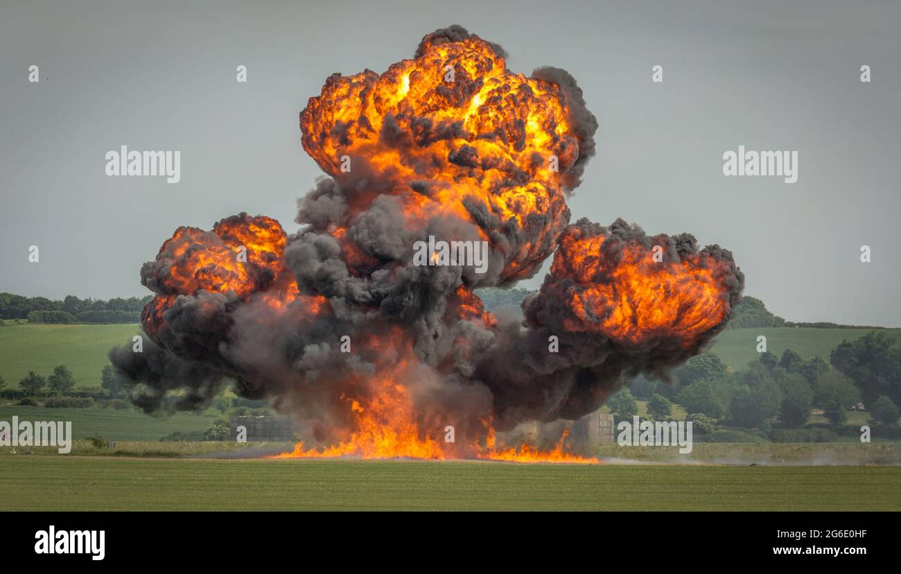 A large explosion during daylight in a field Stock Photo - Alamy