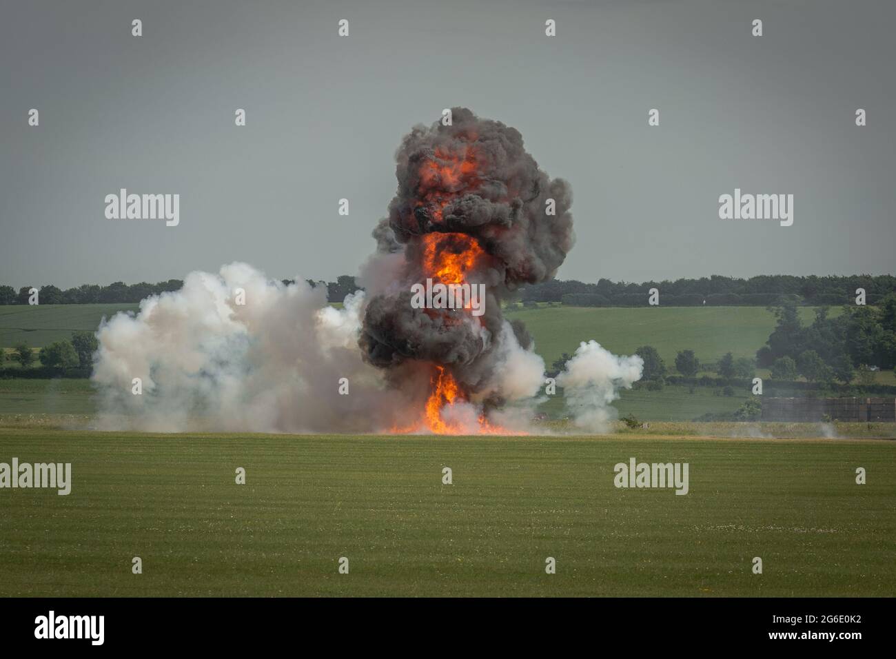 A large explosion during daylight in a field Stock Photo - Alamy