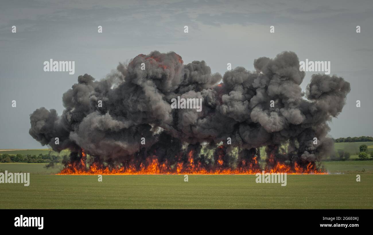A large explosion during daylight in a field Stock Photo - Alamy