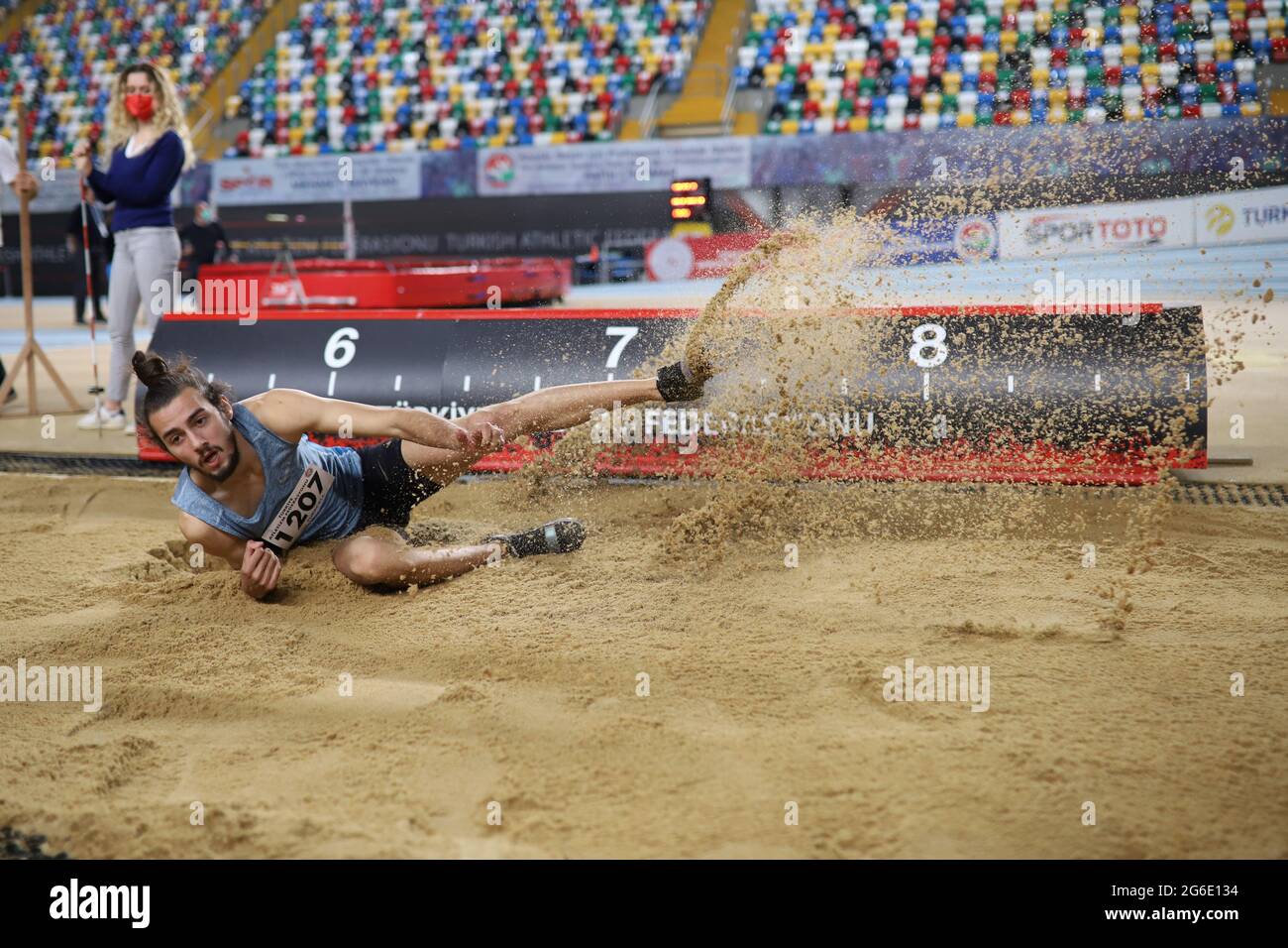 ISTANBUL, TURKEY - MARCH 06, 2021: Undefined athlete long jumping ...