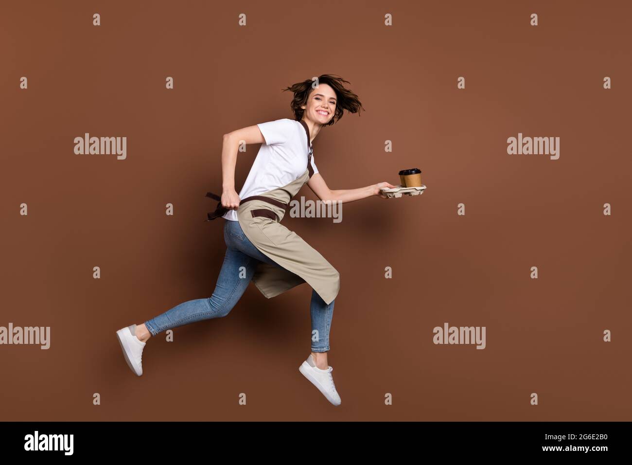 Full length body size view of attractive cheerful girl bringing coffee ...