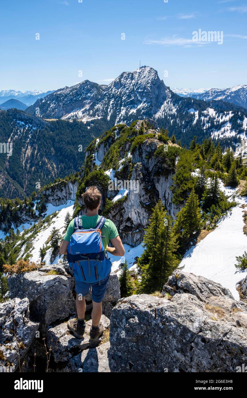 Hiker on the summit of Breitenstein, view to the summit of Wendelstein ...