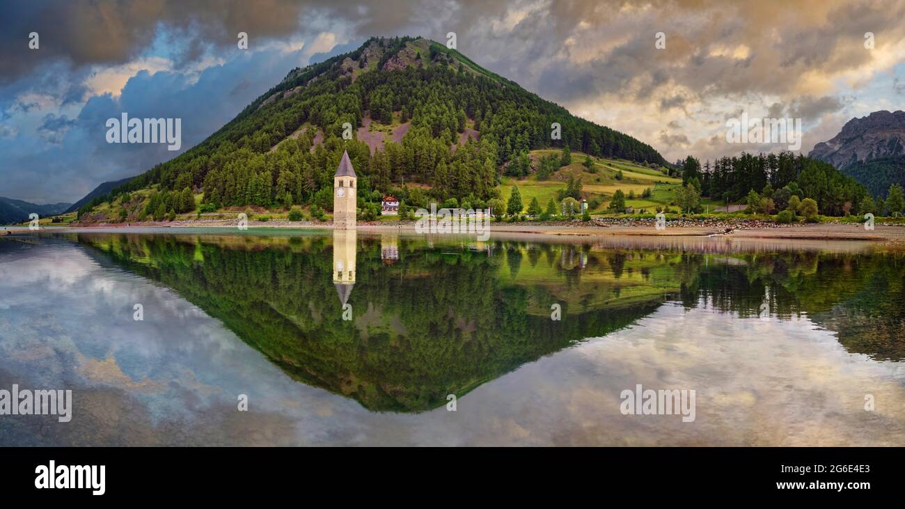 Church tower in the Reschensee with reflection, Graun, Reschen ...