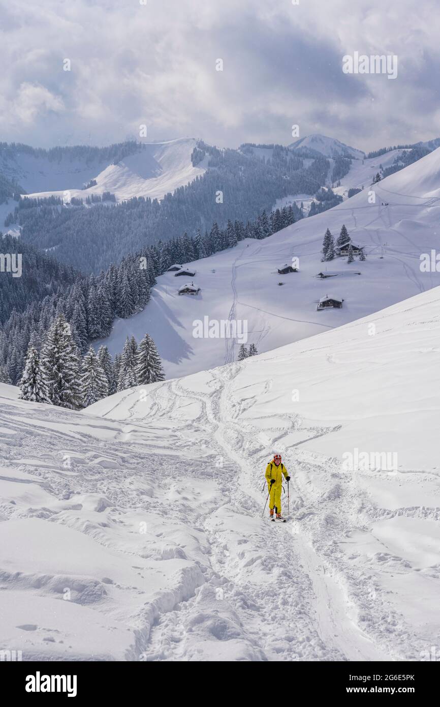 Ski tourers, young man on ski tour to Taubenstein, snowy mountains and ...