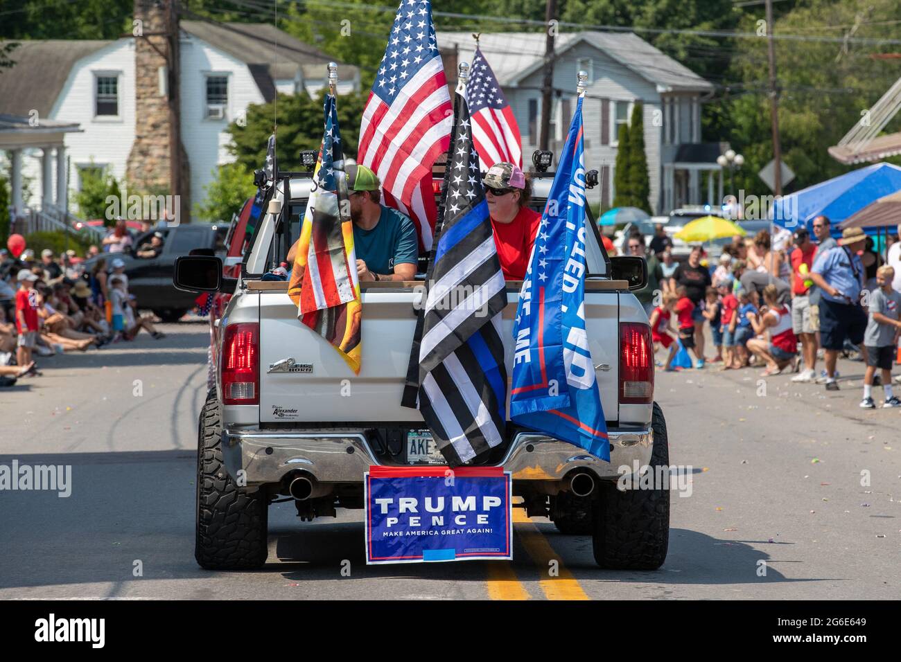 A pickup truck with various flags and Trump/Pence sign is seen in the ...