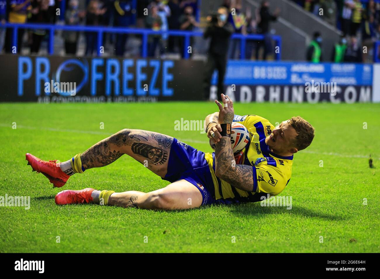 Josh Charnley (5) of Warrington Wolves holds his wrist in pain after ...