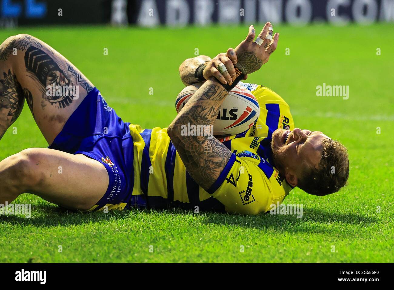 Josh Charnley (5) of Warrington Wolves holds his wrist in pain after ...