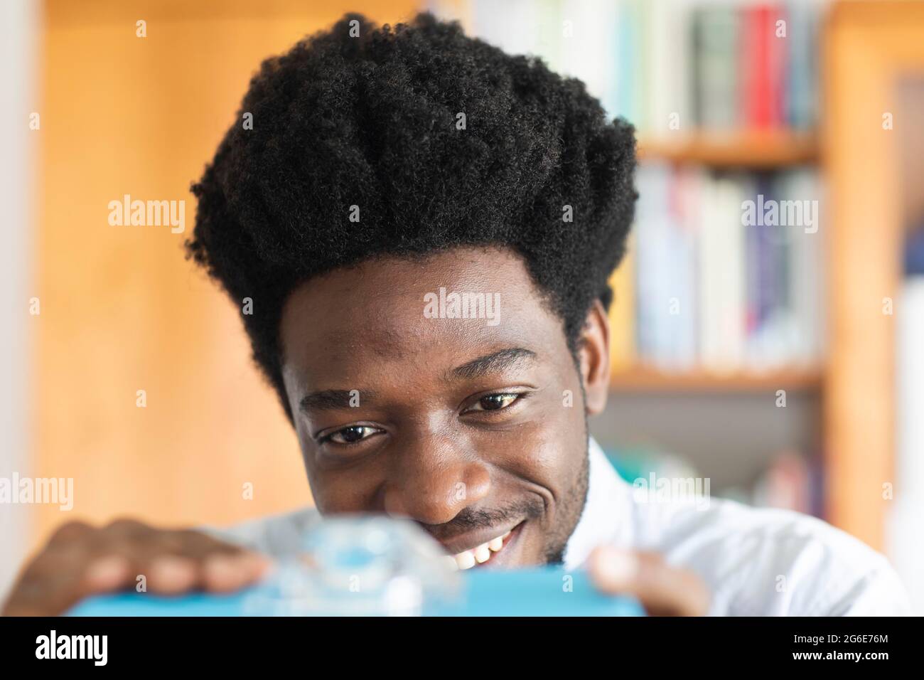 Young black man with afro look looking at an innovation, Freiburg ...
