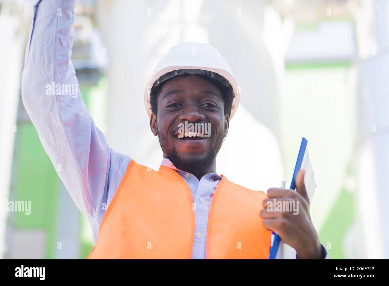 Young black man working outside as technician with helmet and safety ...