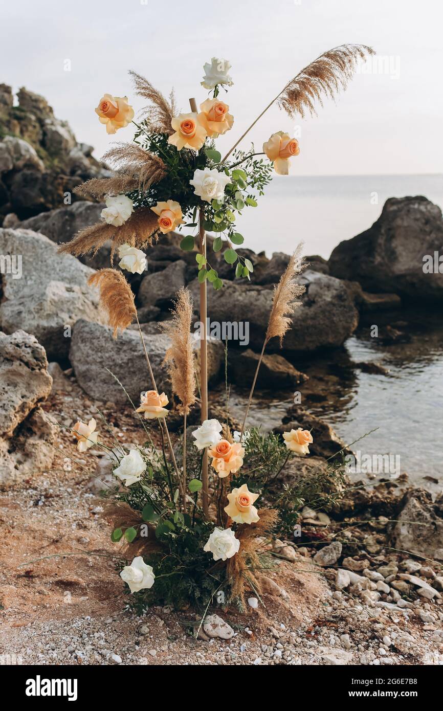 Wedding arch of roses in boho style. Boho eco wedding Stock Photo - Alamy