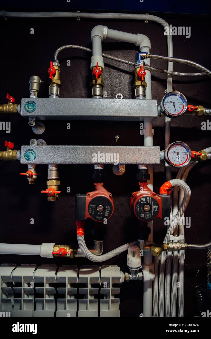 Pipeline of a heating system with pressure gauge Stock Photo - Alamy