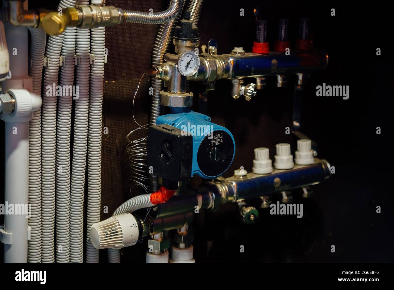 Pipeline of a heating system with pressure gauge Stock Photo - Alamy