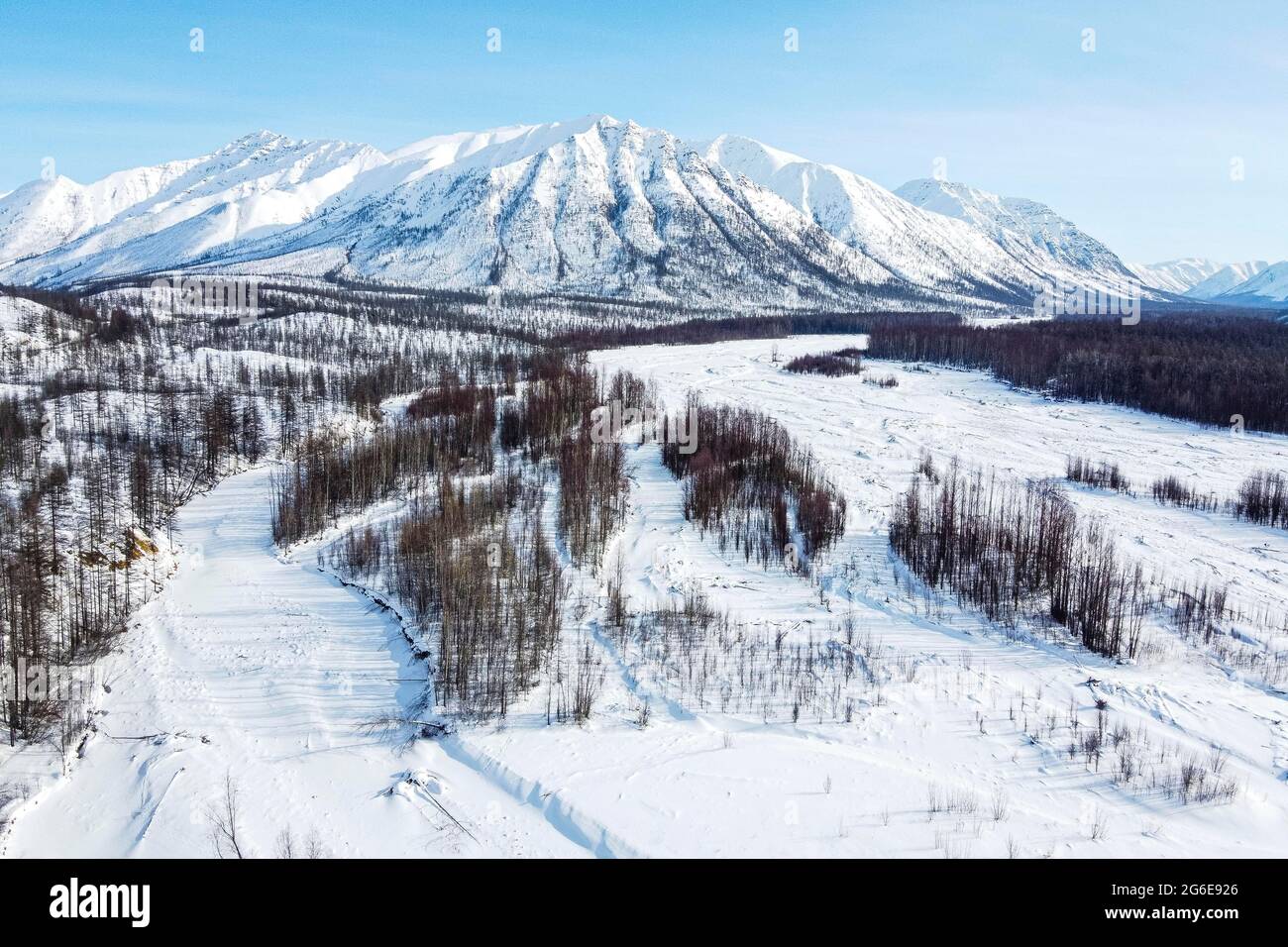 Aerial of the snow covered Suntar-Khayata mountain Range, Road of Bones ...
