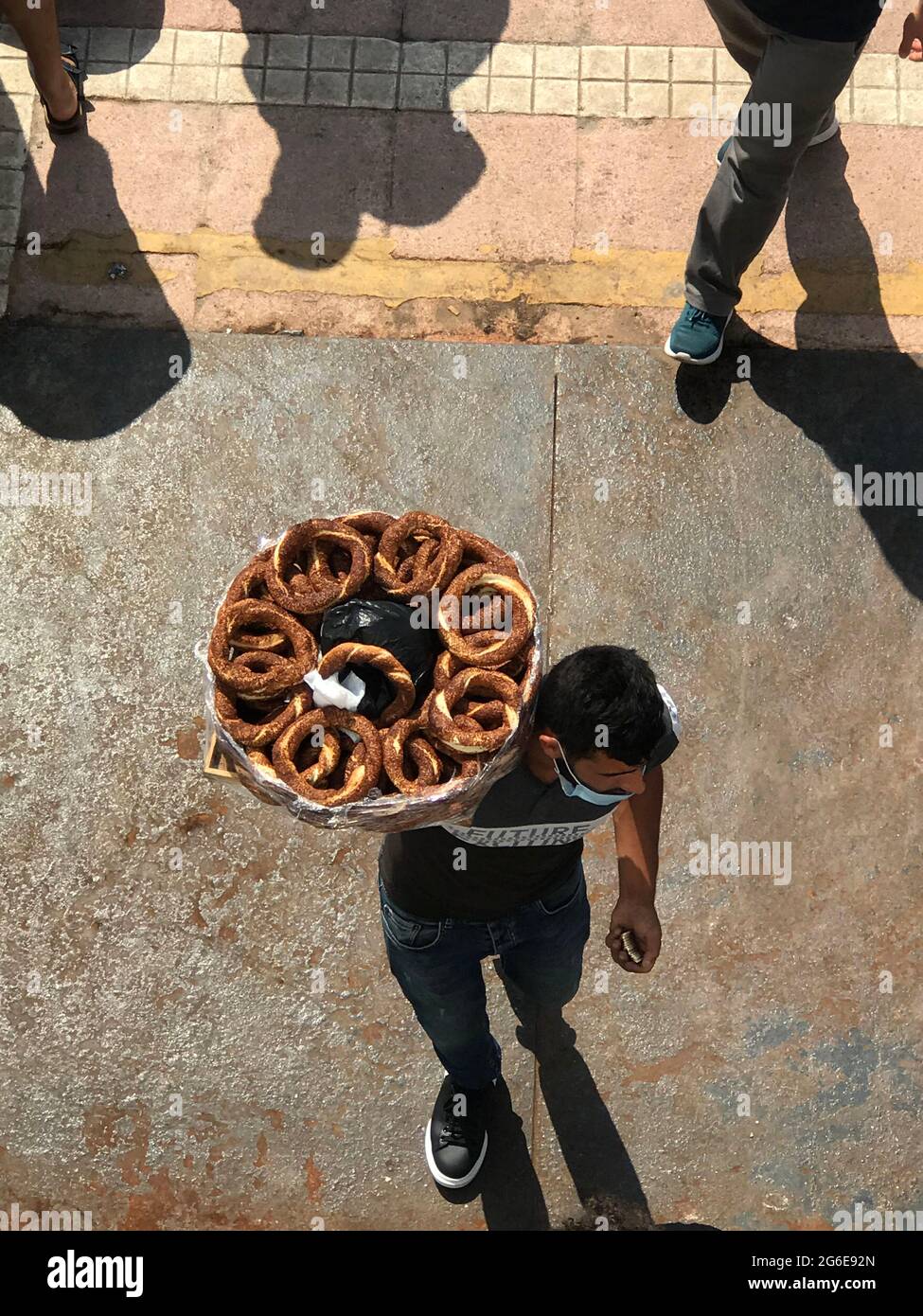 Simit vendor selling simits near ferry boat boarding on Bosphorus Sea ...