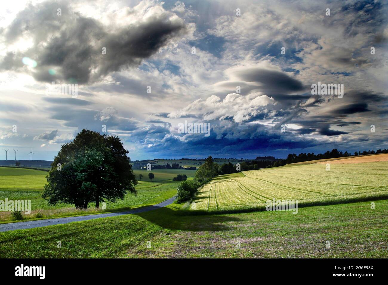 Border triangle, landscape and road, fields, dramatic sky, clouds ...