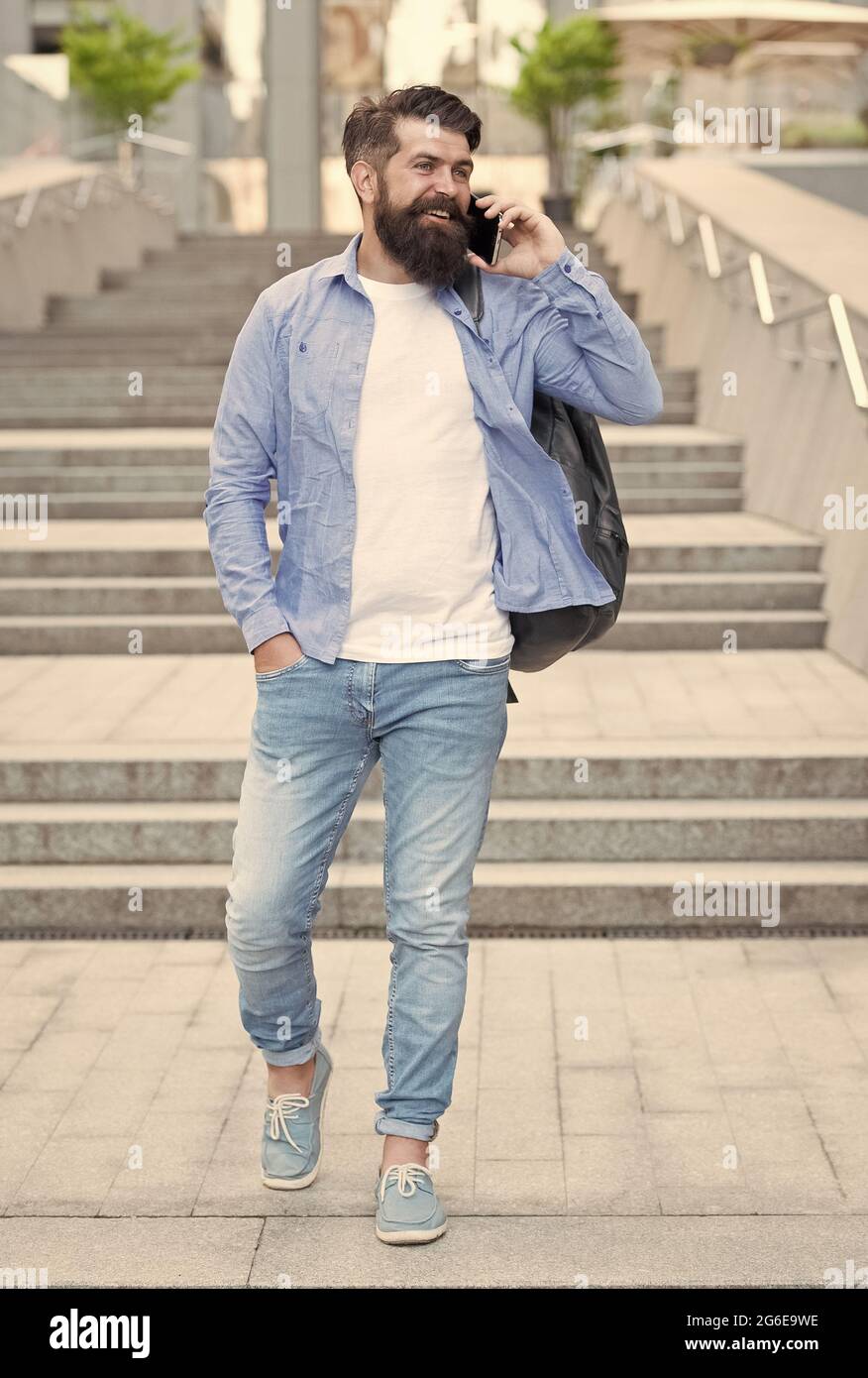 How communication happens. Happy hipster talk on smartphone outdoors ...