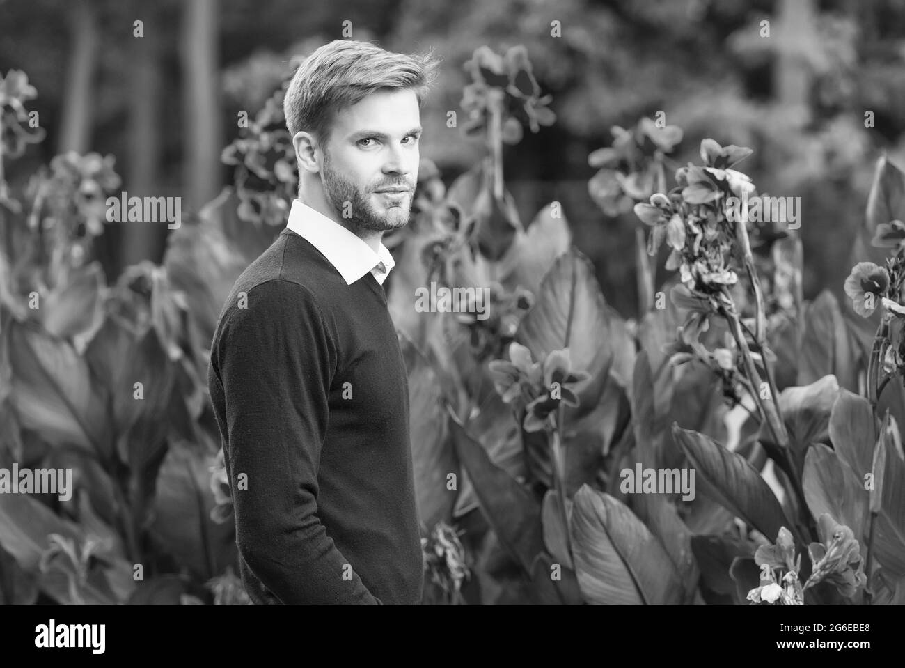 man standing outdoor on spring floral background, mens beauty Stock ...