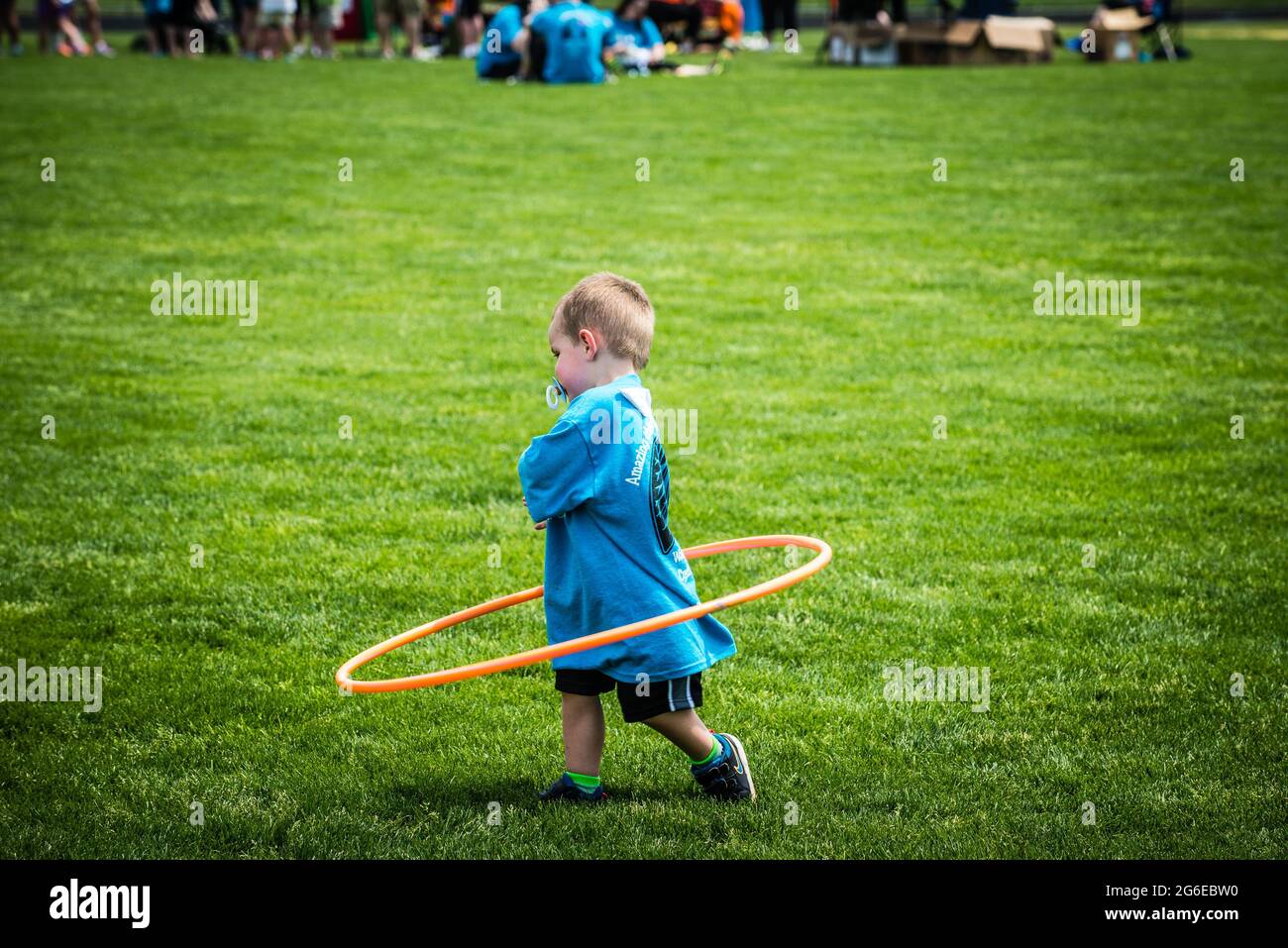Young boy with hula hoop Stock Photo - Alamy