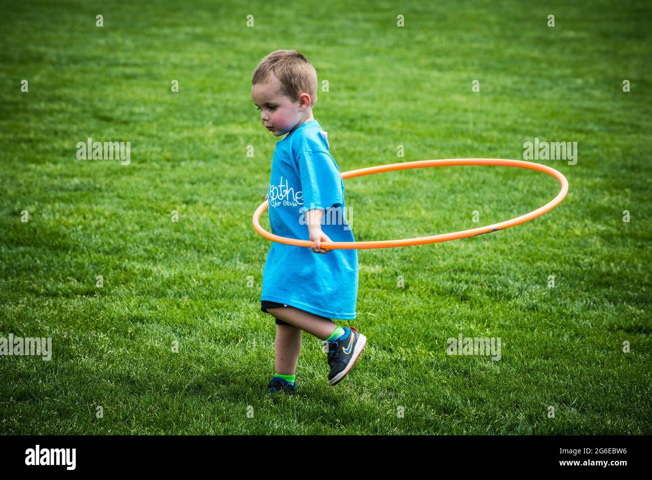 Young boy with hula hoop Stock Photo - Alamy