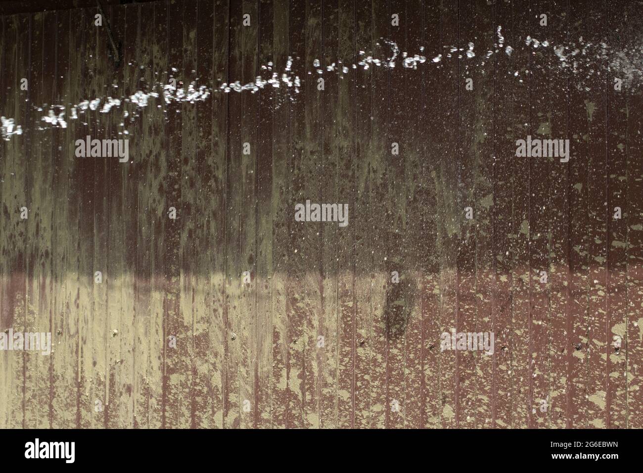 Dirty fence. Mud after rain on the fence at the construction site. The ...