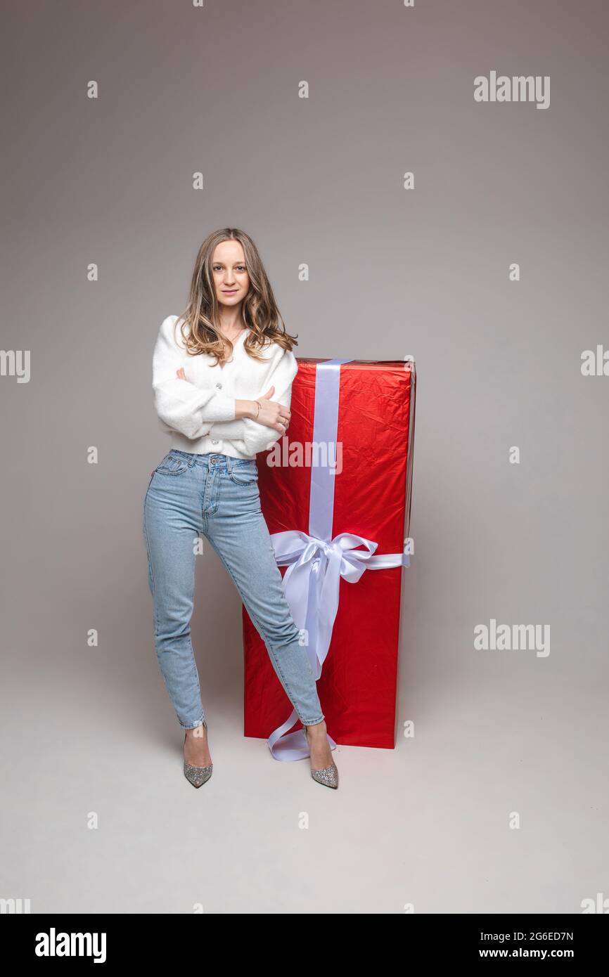 Smiling pretty female with hands folded posing in studio Stock Photo ...