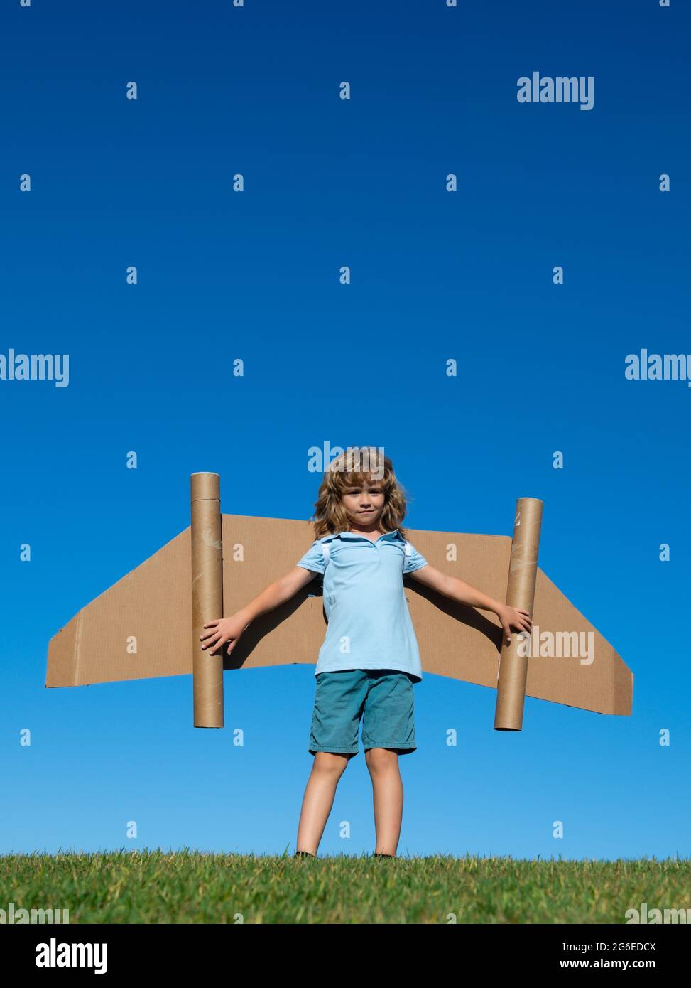 Dreams of travel. Child flying on jetpack with toy airplane on sky ...