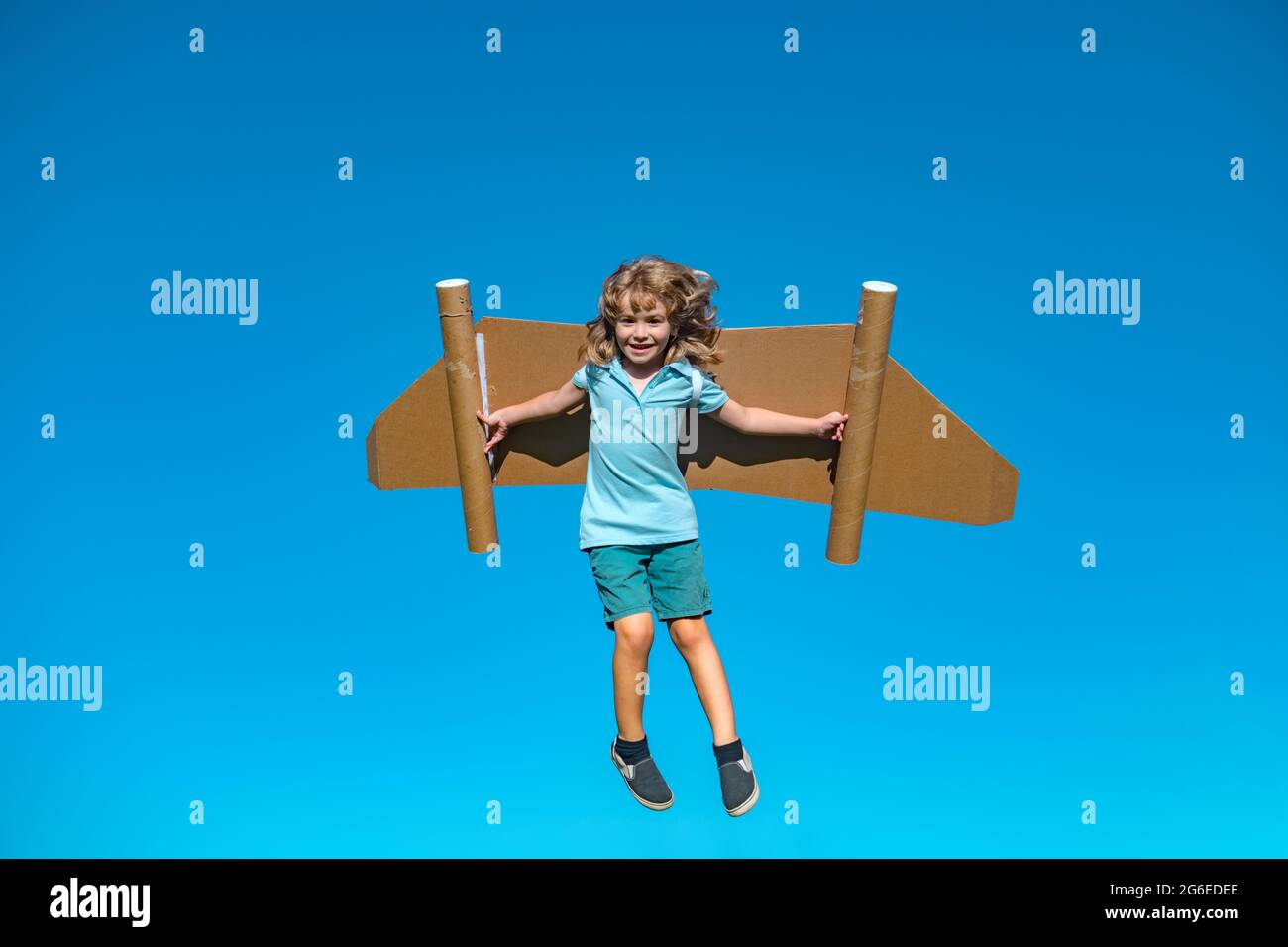 Dreams of travel. Child flying on jetpack with toy airplane on sky ...