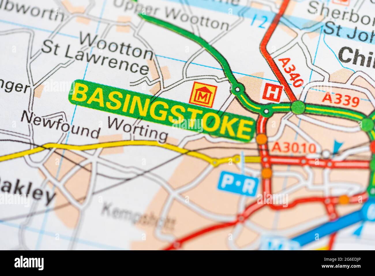 A macro closeup of a page in a printed road map atlas showing the new ...