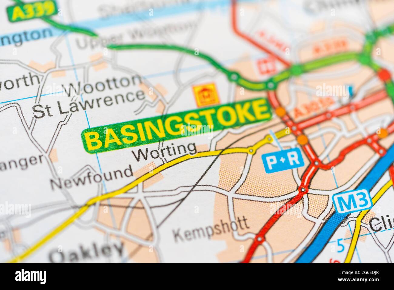 A macro closeup of a page in a printed road map atlas showing the new ...