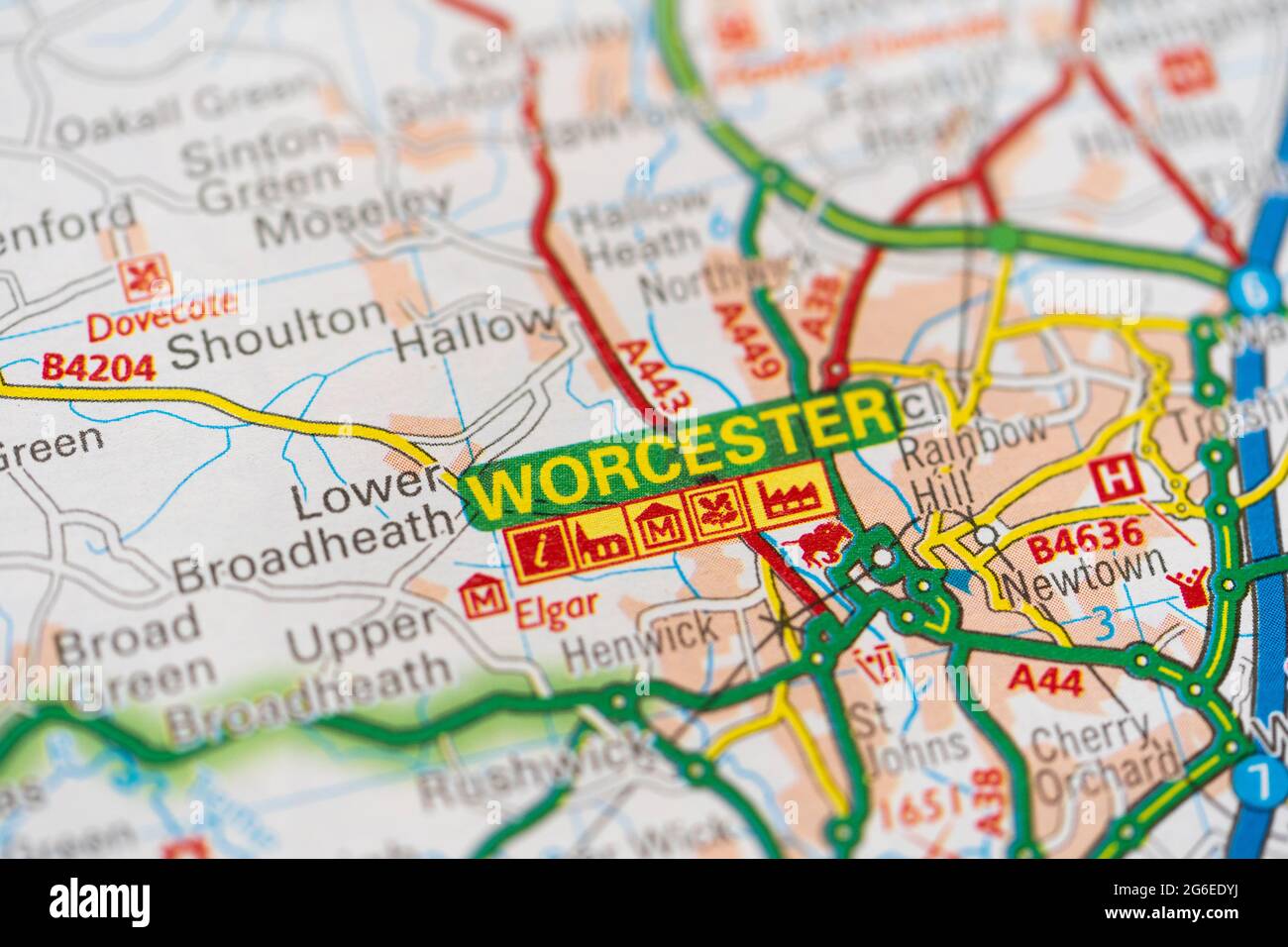 A macro closeup of a page in a printed road map atlas showing the city ...