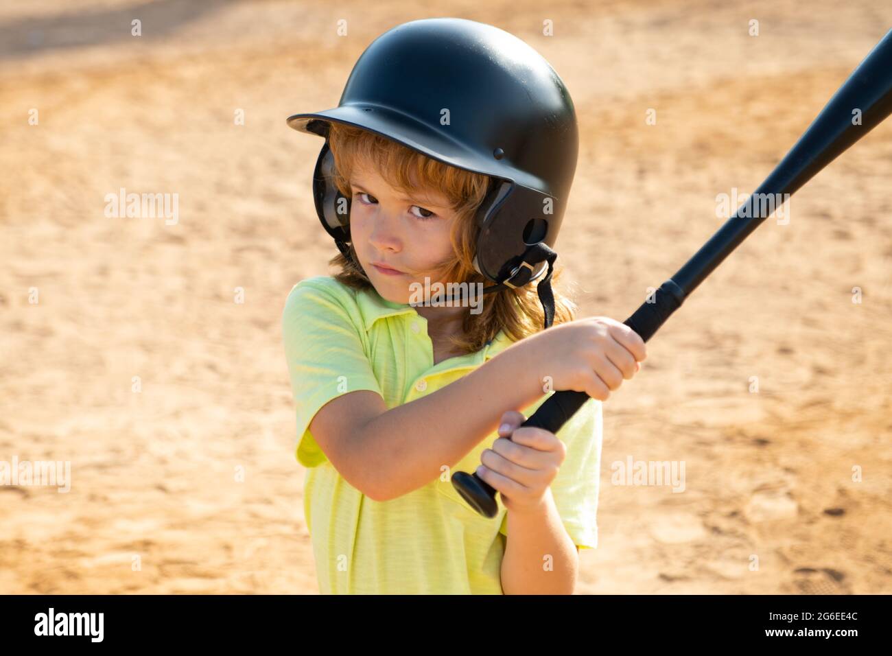 Boy in baseball helmet and baseball bat ready to bat Stock Photo - Alamy