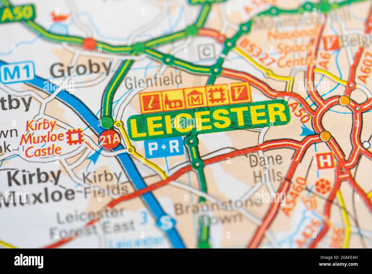 A macro closeup of a page in a printed road map atlas showing the city ...