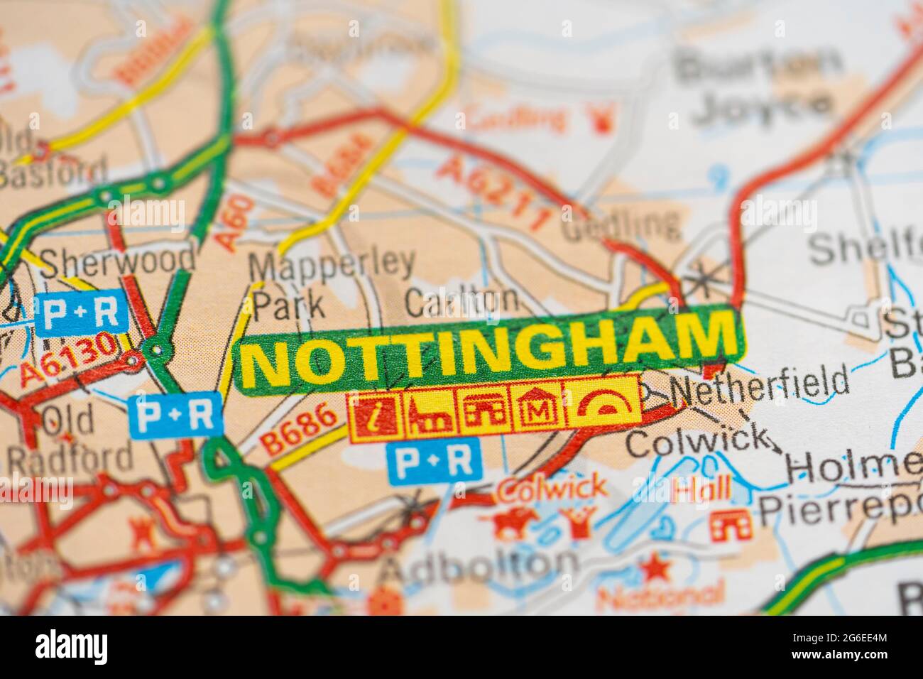 A macro closeup of a page in a printed road map atlas showing the city ...