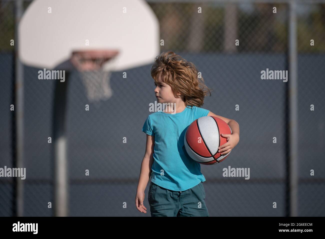 Cute smiling boy plays basketball. Active kids enjoying outdoor game ...