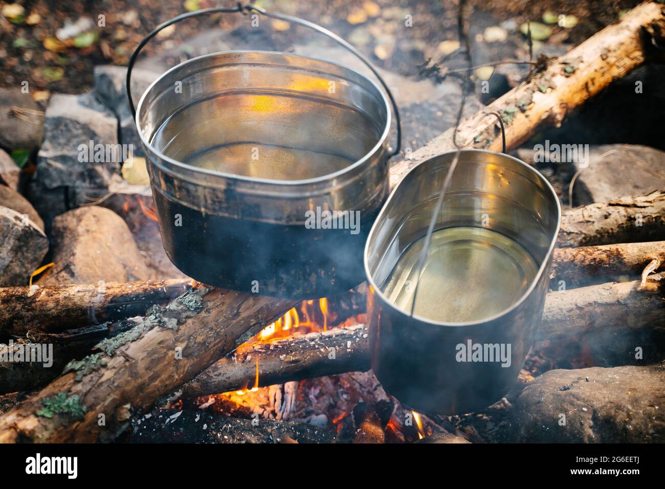 Cooking in field conditions on a fire Stock Photo - Alamy