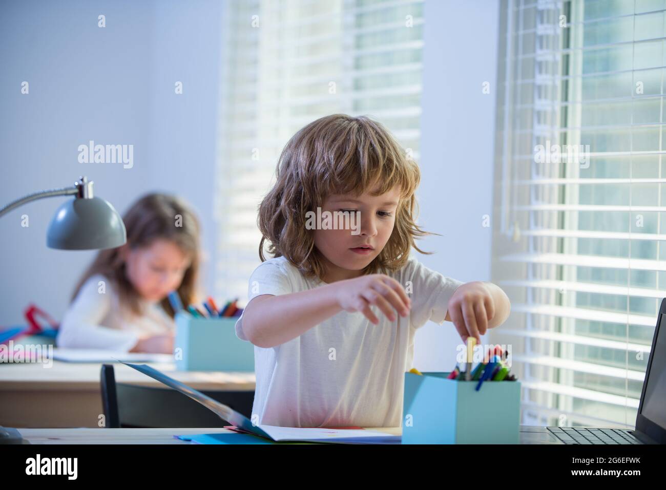 School kid doing homework. Pupil gets ready for school. Portrait of ...