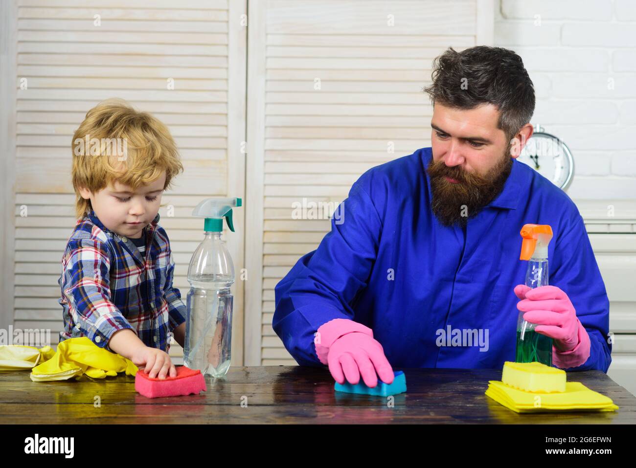 Man cleaning house together at home. Father and son with clean supplies ...