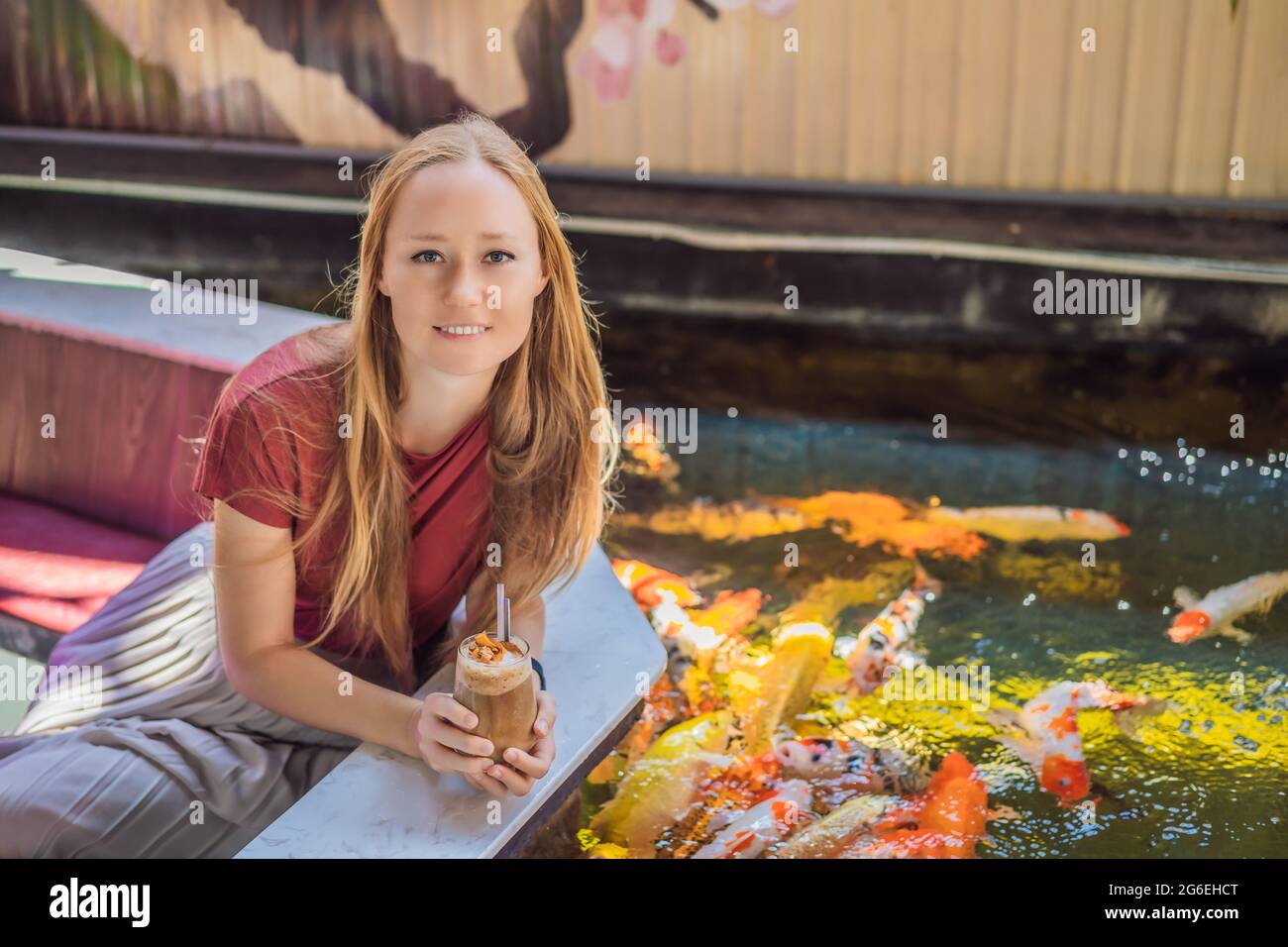 Woman feed koi fish. Beautiful koi fish swimming in the pond Stock ...