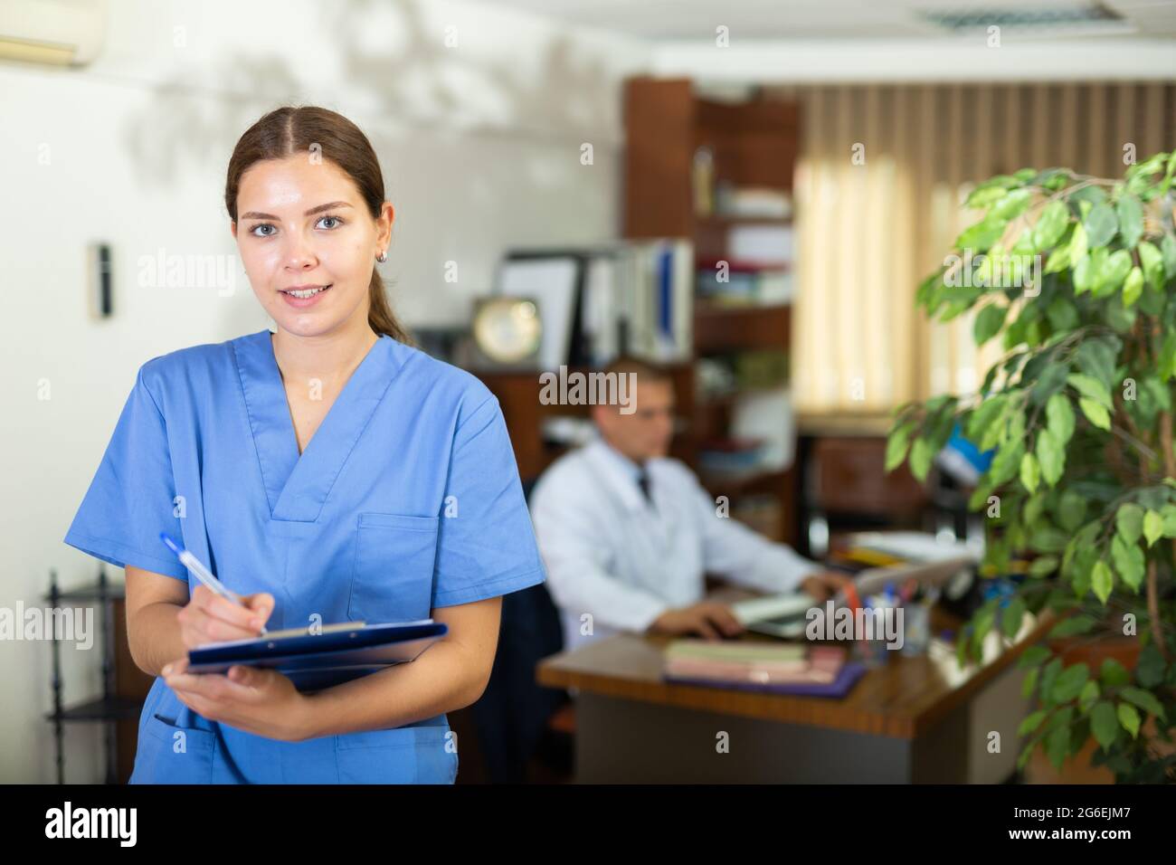 Woman doctor wear white medical uniform with folder of documents Stock ...