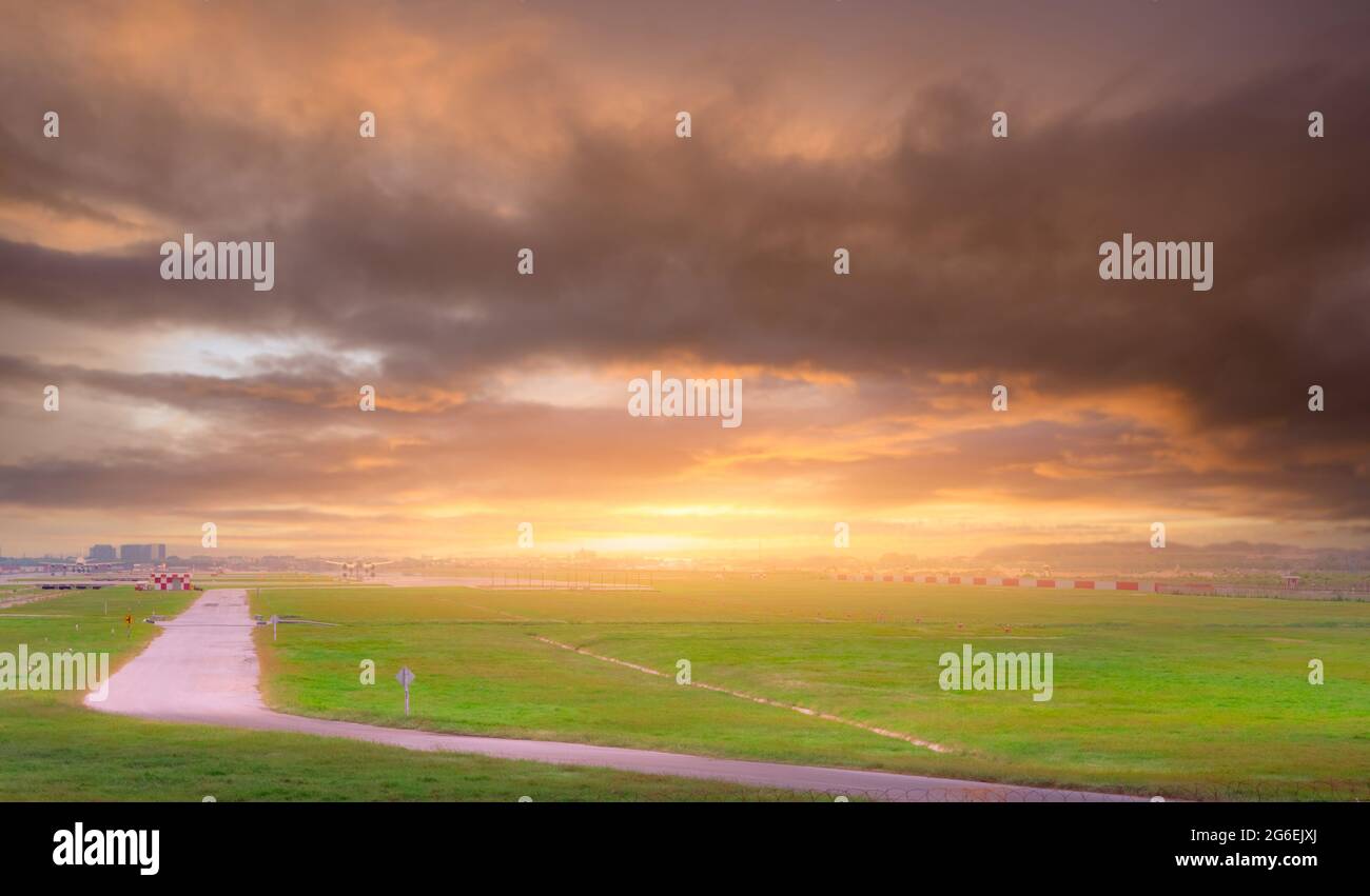Landscape of green grass field at the airport. Blur runway with ...