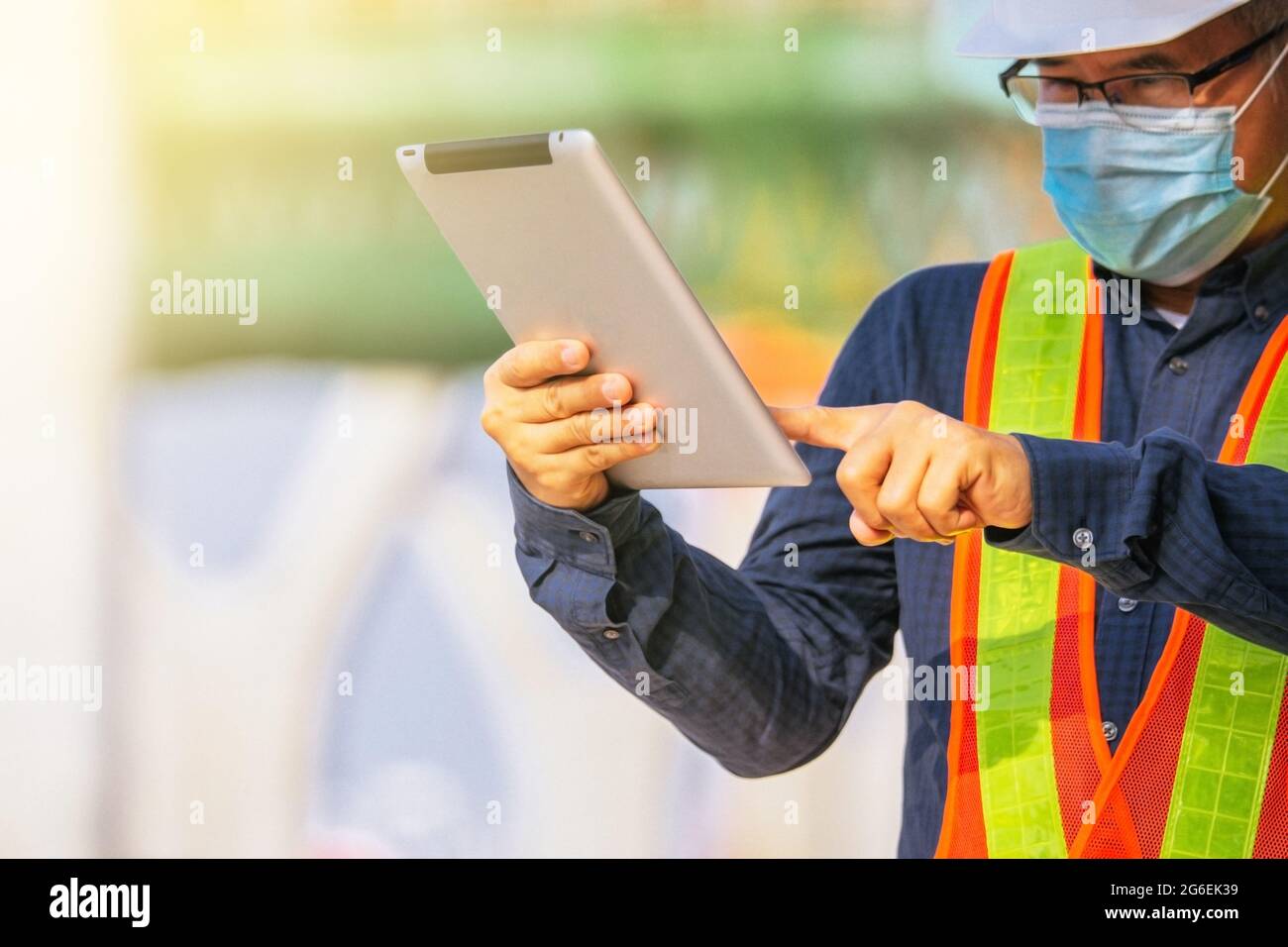 Engineer hold tablet working site construction Stock Photo - Alamy