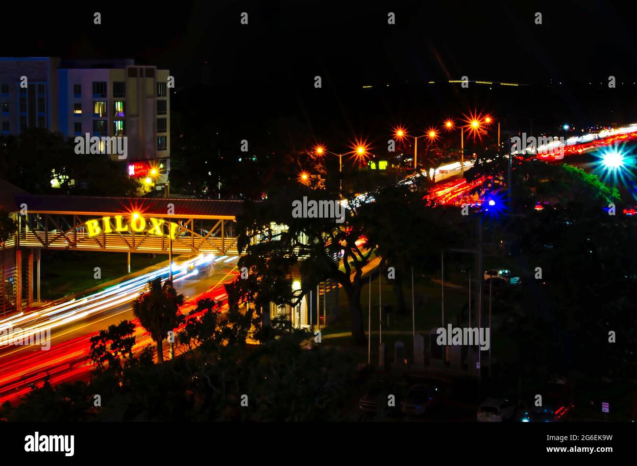 Traffic travels on Highway 90 beneath a Biloxi sign on a pedestrian ...