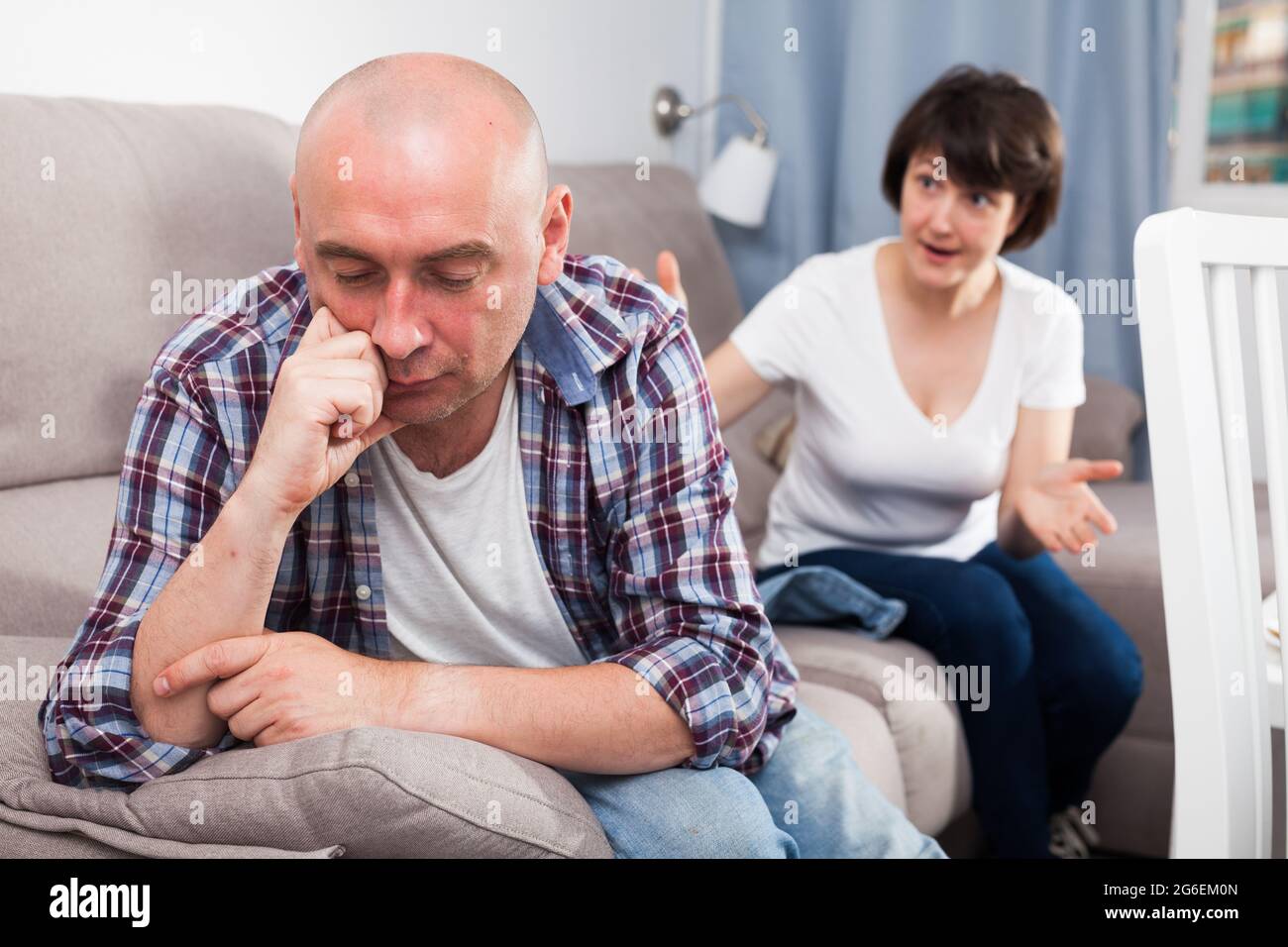 Sad family having difficulties in the living room at home Stock Photo ...