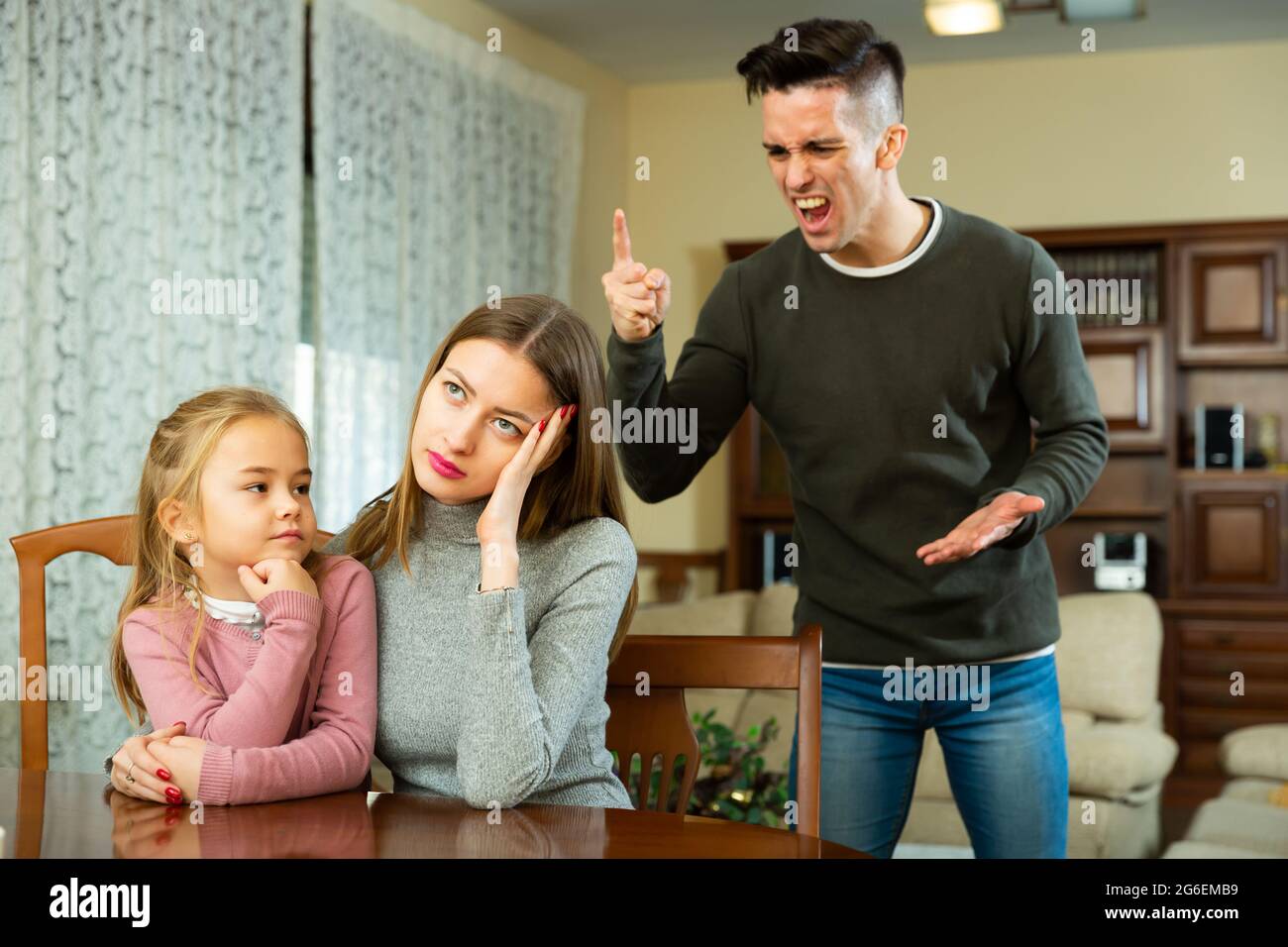 Upset girl and mother with angry father Stock Photo - Alamy
