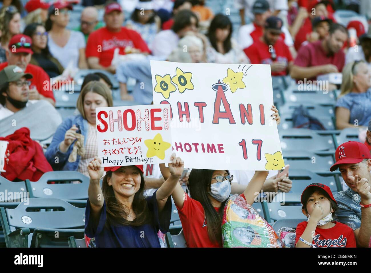 Fans hold up signs for Los Angeles Angels two-way player Shohei Ohtani ...