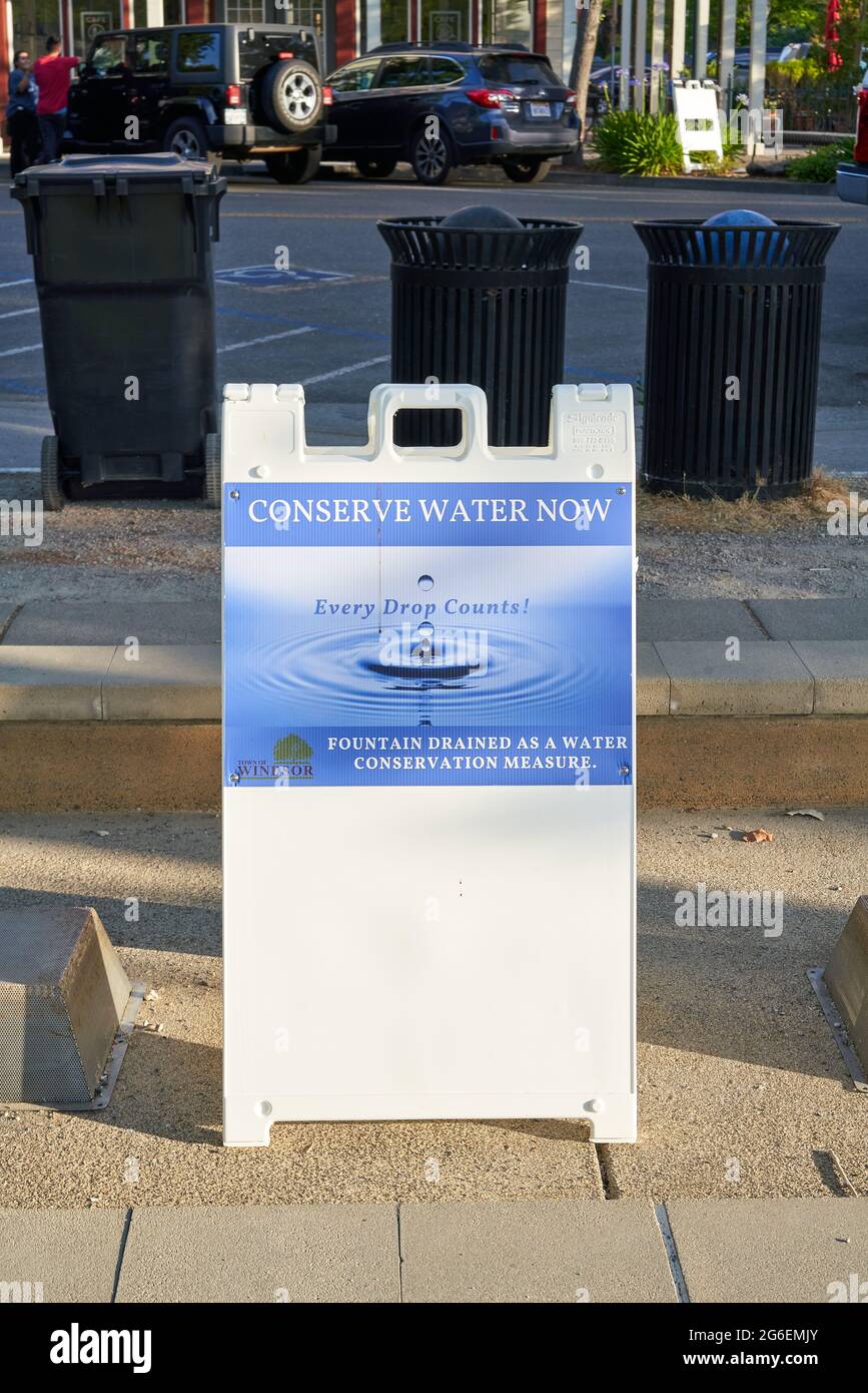 Empty water fountain with sign urging the public to conserve water, in ...