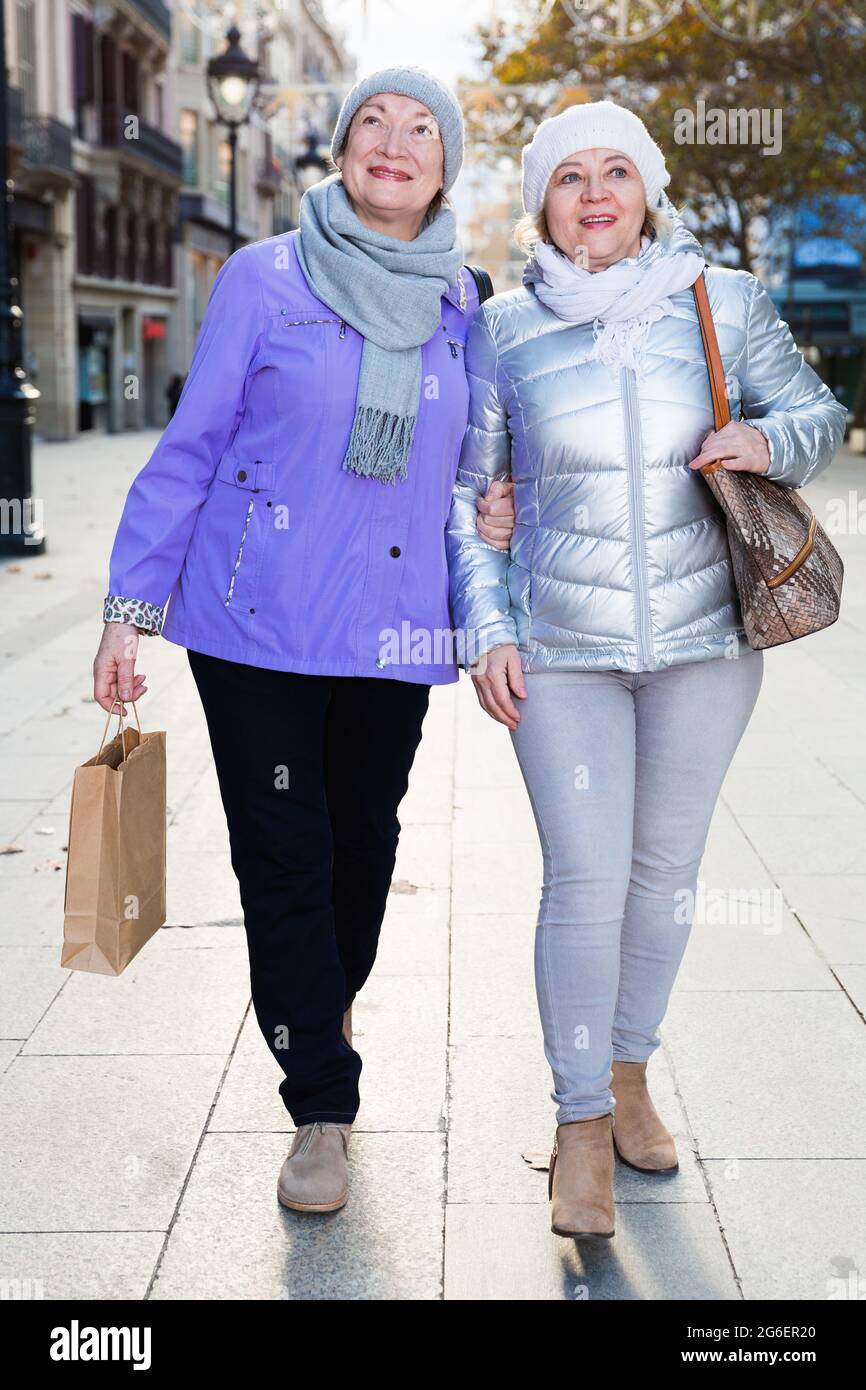 Senior females walking along city streets Stock Photo - Alamy