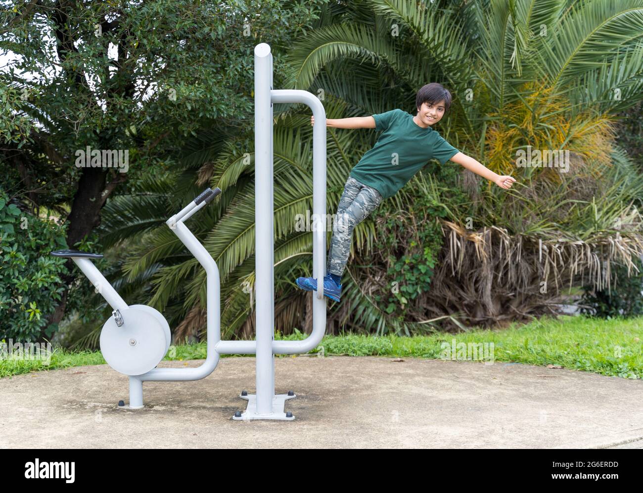 Active child climbed on top of gym equipment at park. Physical activity ...