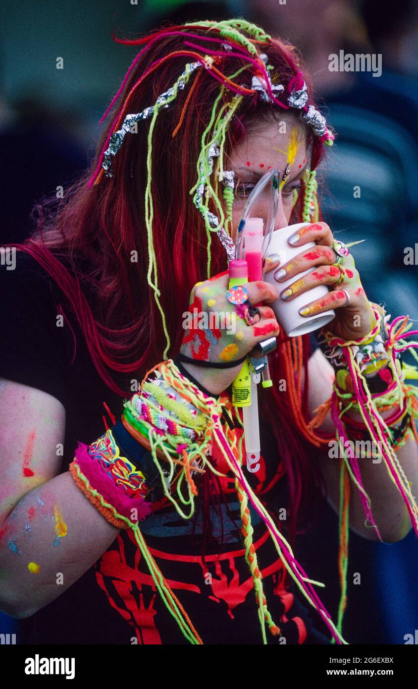 A young woman having a hot drink in the early morning after attending ...