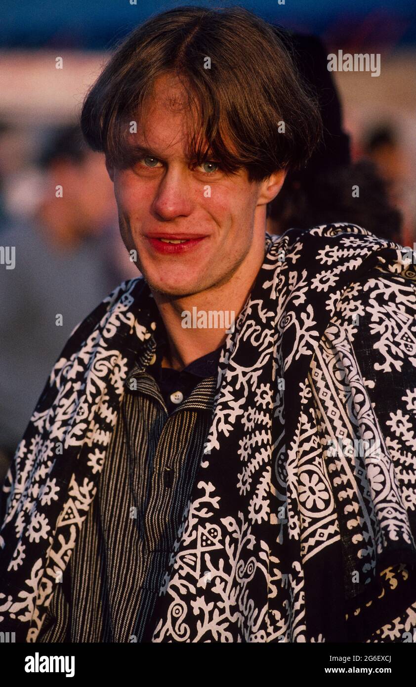 A young man lit by early morning light after attending, Tribal ...
